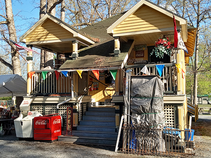 The yellow clapboard headquarters stands proudly with its festive pennant flags, vintage Coca-Cola coolers hinting at refreshment and nostalgia.