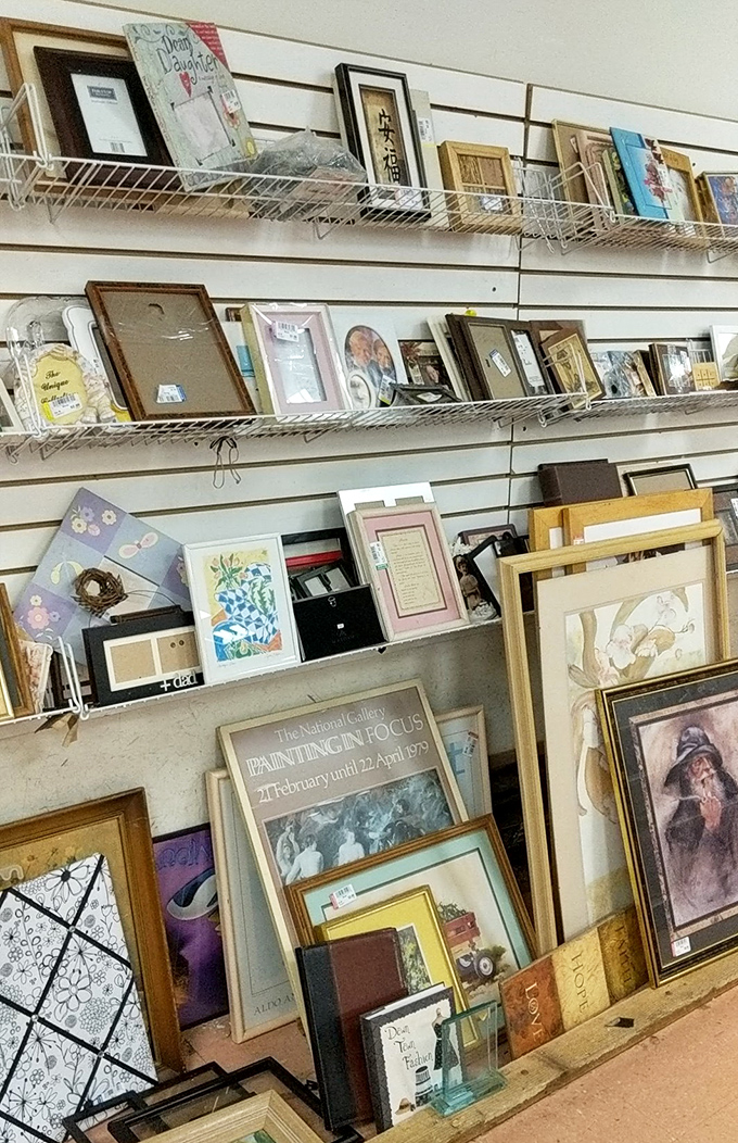 Frame heaven! One person's discarded wall art becomes another's statement piece in this carefully organized display of potential.