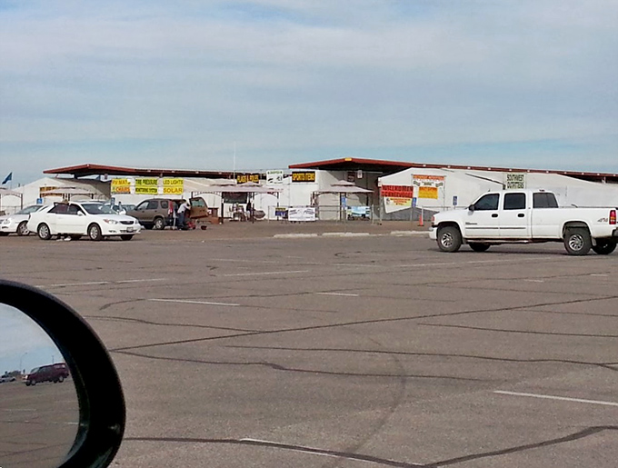 White-washed buildings with red awnings stand ready for treasure hunters, a retail oasis in Yuma's sunbaked landscape.