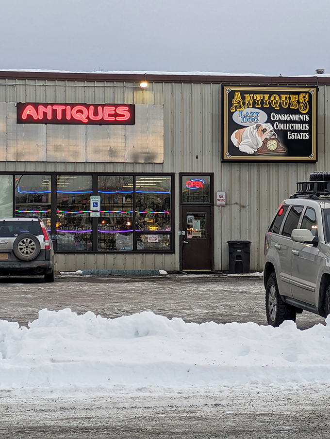 Even on snowy Anchorage days, the glowing neon "ANTIQUES" sign serves as a lighthouse for collectors navigating the sea of modern retail.