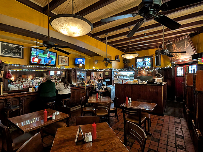 Yellow walls, dark wood, and ceiling fans create the perfect atmosphere for serious burger contemplation &ndash; no distractions, just anticipation.