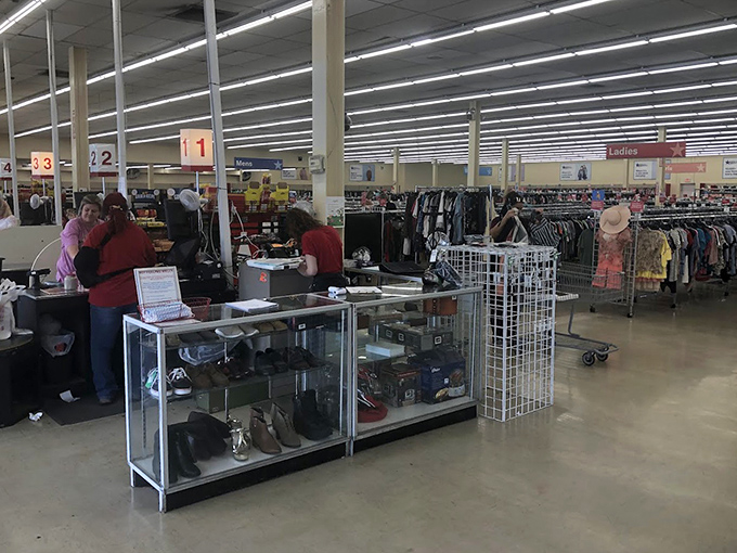 The checkout area buzzes with activity as shoppers prepare to exit with carts fuller than their wallets are empty.