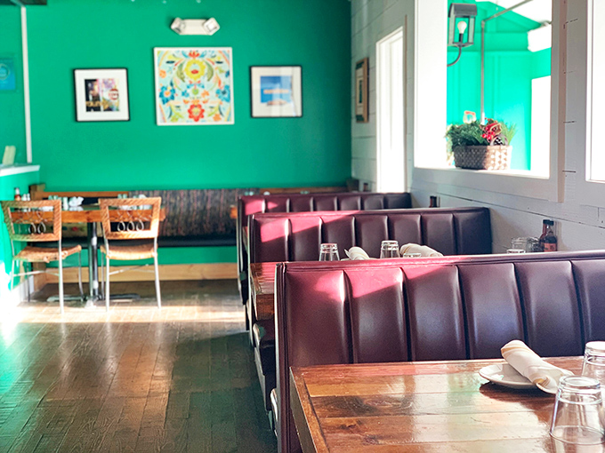 Those vibrant green walls aren't just a design choice&mdash;they're a mood enhancer. The burgundy booths invite you to sink in and stay awhile.
