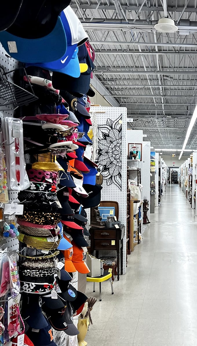 Endless aisles of possibility where baseball caps and belts hang like colorful stalactites in this cave of collectibles.