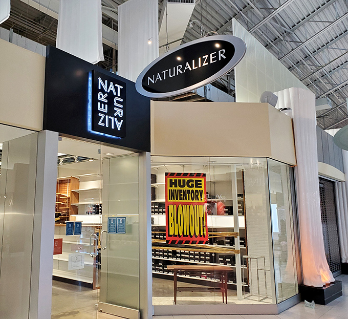Naturalizer's "HUGE INVENTORY BLOWOUT" sign—three magic words that make bargain hunters' hearts beat faster than after their third espresso.
