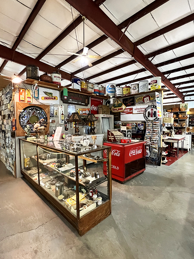 Vintage Americana comes alive with this classic Coca-Cola cooler standing sentinel among display cases filled with memories and collectibles.