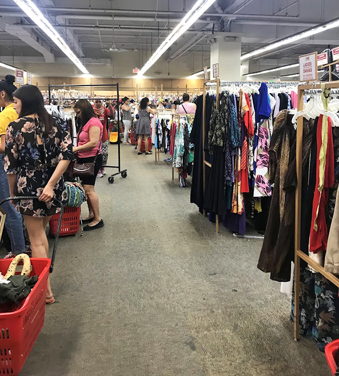 Inside this fluorescent-lit wonderland, shoppers navigate a sea of potential finds with their trusty red baskets at the ready.