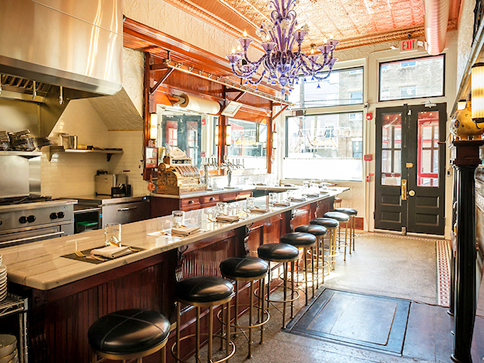 The purple chandelier hanging over the marble counter creates dining theater. Watch pasta masters work their magic while perched on those inviting bar stools.
