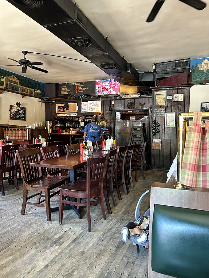 Where time stands still but hunger doesn't—wooden chairs, worn floors, and ceiling fans spinning stories of countless satisfied diners before you.