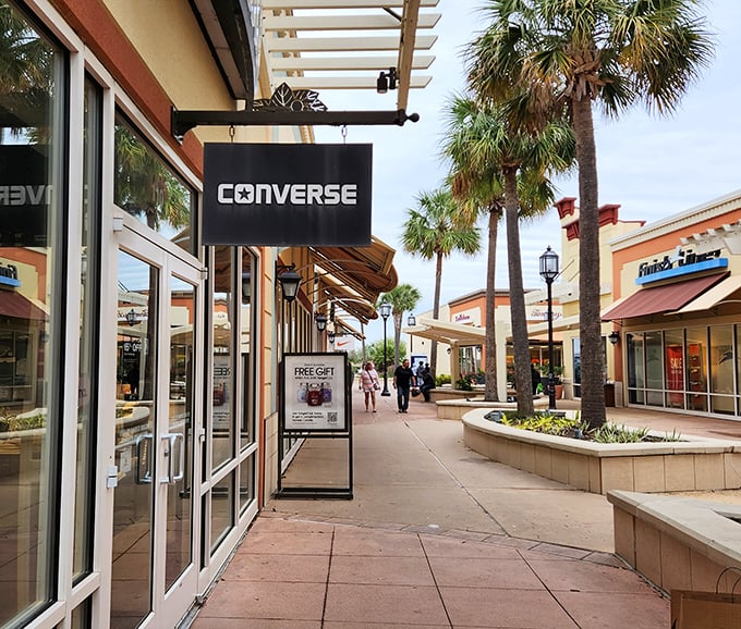 Palm trees and pastel-colored storefronts create that distinctly Gulf Coast vibe. Converse and other brands line this shopping street that never saw a discount it didn't like.