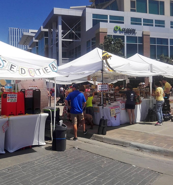 White tents create a patchwork village against modern architecture, where rural traditions and urban convenience find perfect harmony.