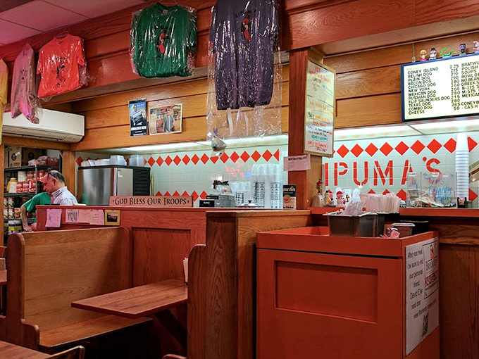 Wooden booths worn smooth by decades of diners tell stories of countless conversations. The "God Bless Our Troops" sign speaks volumes about Lipuma's community values.