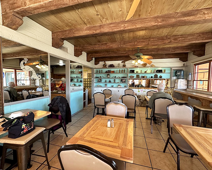 Rustic wooden beams meet turquoise shelving in this dining room that somehow manages to feel both exotic and like your favorite aunt's kitchen.