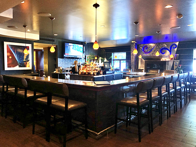 The bar stretches like a runway for cocktails, inviting you to settle in for the evening ahead.