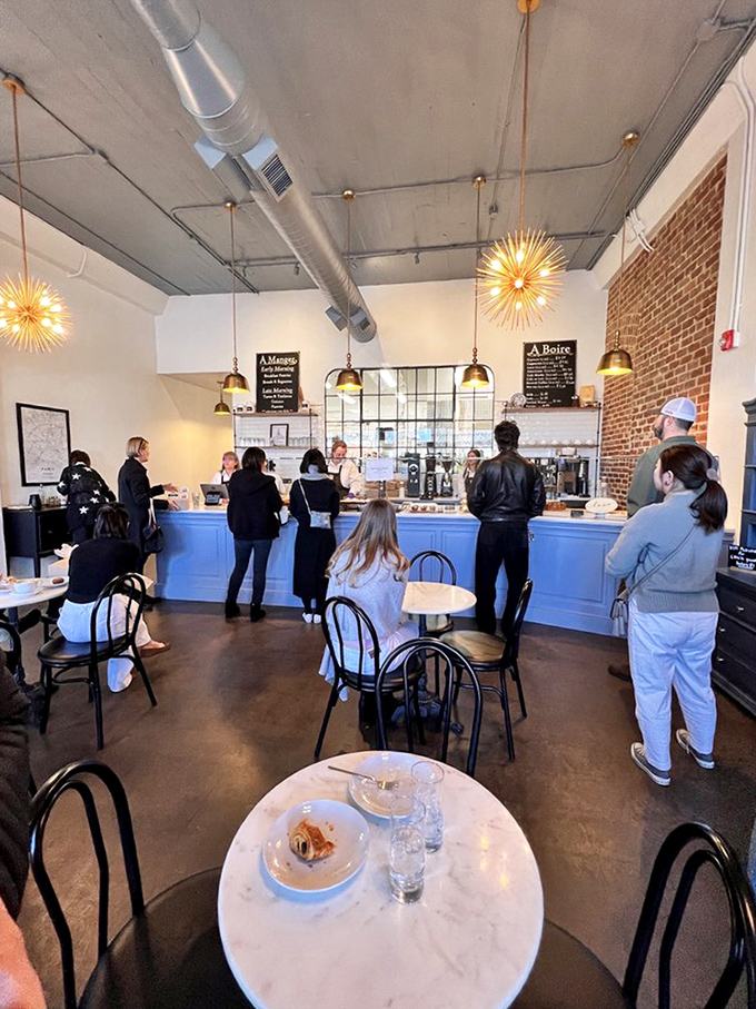 Step inside and the world slows down. The industrial-chic ceiling meets warm lighting and that unmistakable aroma of butter and sugar working their magic.