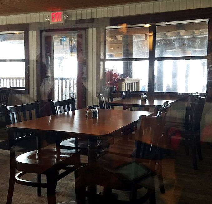 Simple wooden tables with water views remind us that sometimes the best dining rooms aren't about chandeliers, but about what's beyond the windows. 