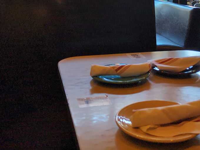 Simple table settings await the pizza magic to come. Like a blank canvas before a masterpiece, these plates will soon hold some of San Francisco's most celebrated slices.