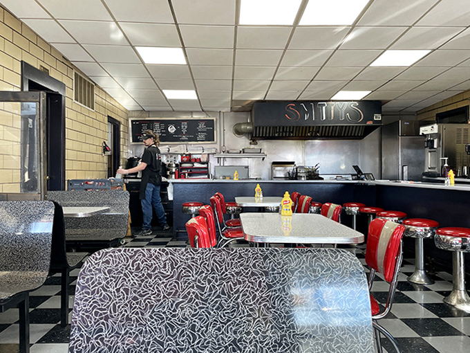 A classic American diner frozen in time—checkerboard floors, red vinyl stools, and the promise of comfort food that makes you forget your diet resolutions.