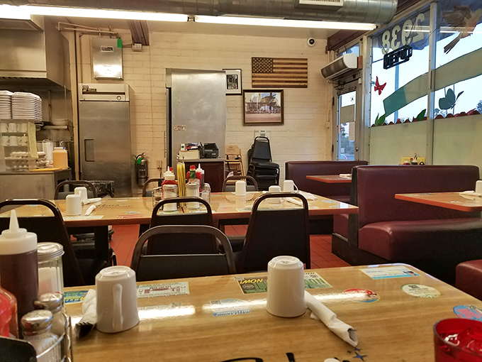 Classic diner simplicity at its finest. Red vinyl booths, wooden tables, and the promise of coffee refills create the perfect backdrop for breakfast bliss.