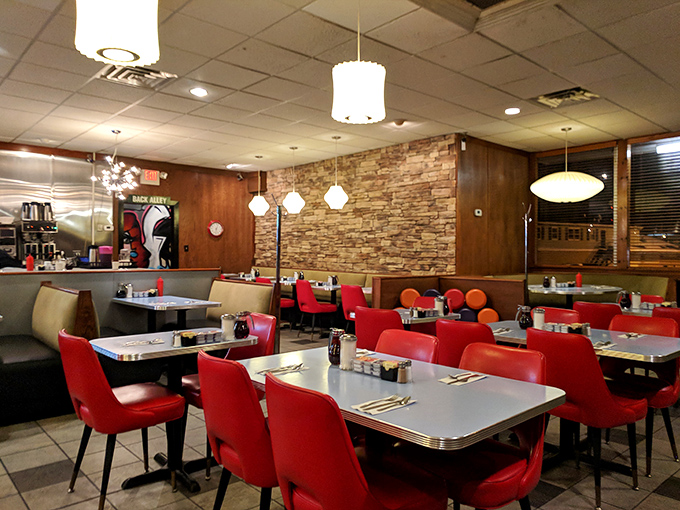 Step inside and you're transported to a mid-century wonderland where those cherry-red chairs practically whisper, "Sit down, stay awhile."