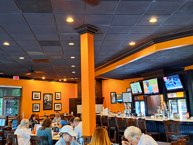 Vibrant orange walls and wooden accents create that perfect "welcome home" atmosphere where conversations flow as freely as the coffee.