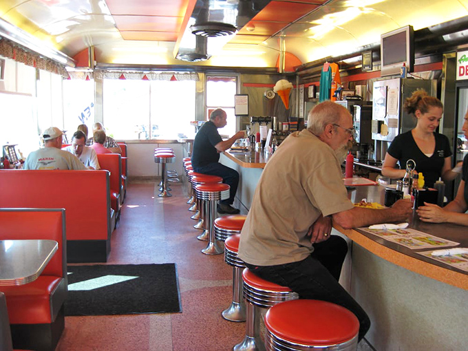 Classic red vinyl booths and chrome counter stools &ndash; where regulars perch to watch the breakfast ballet unfold behind the grill.
