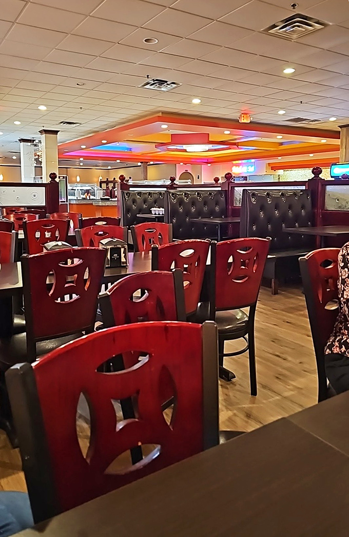 Colorful ceiling panels and distinctive red chairs create an atmosphere that says, "Stay awhile, there's plenty more where that came from."