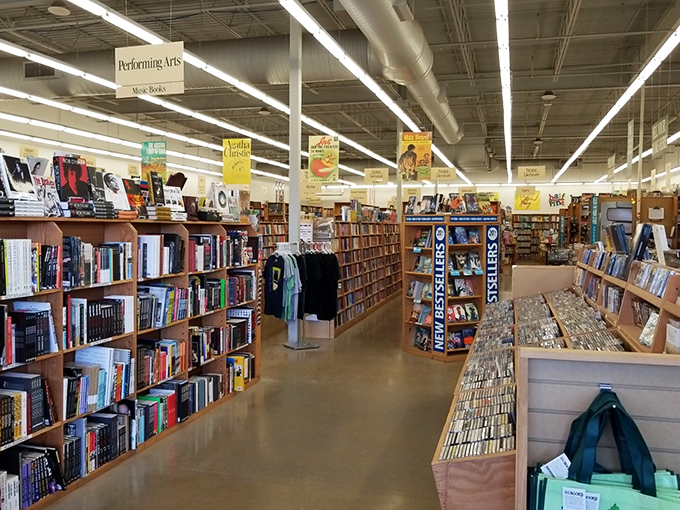 Endless aisles of possibility stretch before you, where hanging signs guide your literary journey through this paper-filled paradise.