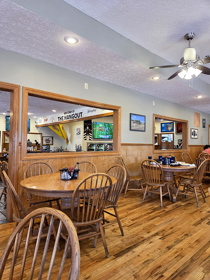 Windsor chairs and warm wood paneling create that "grandma's dining room" vibe, minus the plastic-covered furniture and awkward family questions.