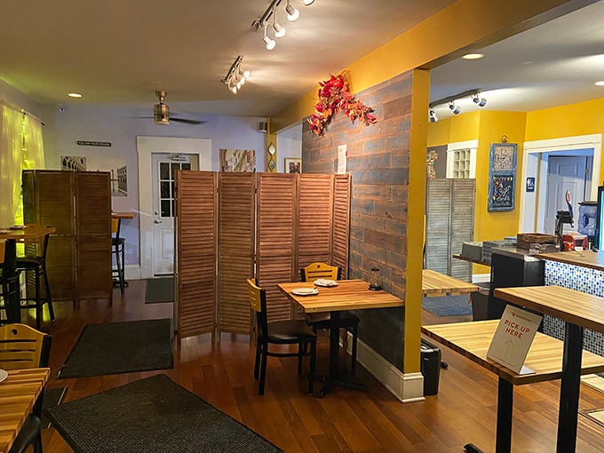 Warm yellow walls and wooden dividers create intimate dining nooks that feel like you've stumbled into someone's stylish Italian home rather than a restaurant. 