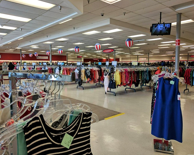 Rows upon rows of clothing stretch into the distance like a retail mirage. Those red, white, and blue balloons aren't just decorative&mdash;they're celebrating your impending bargain victory.