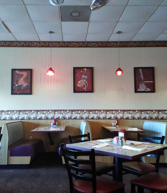 Cozy booths and simple decor create that perfect "everybody knows your name" vibe. The red pendant lights cast a warm glow that makes every meal feel like comfort.