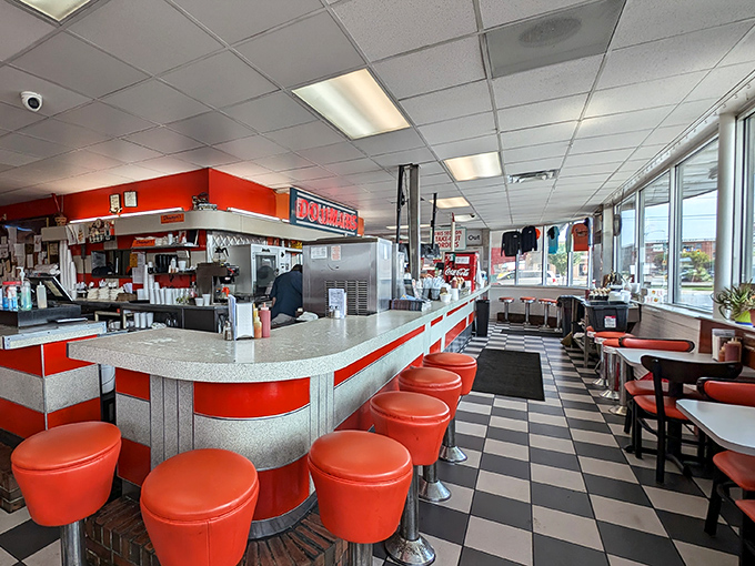 Classic diner perfection with those fire-engine red stools just begging for a spin. Go ahead, nobody's watching—except everyone at the counter.