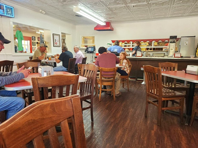 Inside, wooden chairs and red-topped tables create that perfect "come as you are" atmosphere where conversations flow as freely as the sweet tea.