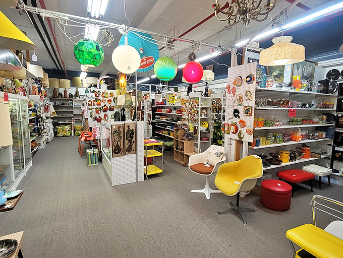 Mid-century modern meets retro chic in this colorful vendor space where hanging globe lamps cast a glow over yesterday's design treasures.