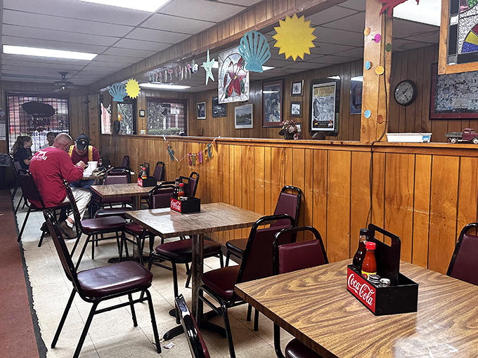 Wood-paneled walls and Coca-Cola caddy tables create a time capsule where conversations matter more than Instagram filters.