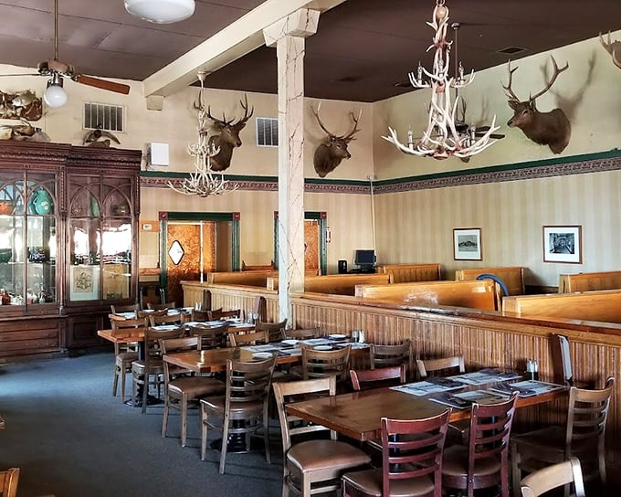 Antler chandeliers and mounted trophies watch over diners, creating an atmosphere that whispers tales of California's wild west without saying a word.