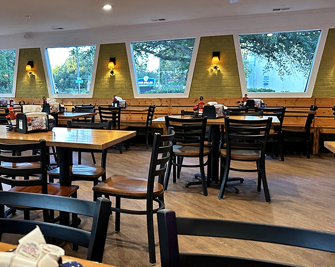 Angled windows flood the dining room with natural light, creating the perfect backdrop for morning conversations and waffle-induced happiness.