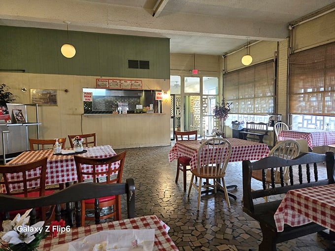 Red and white checkered tablecloths set the stage for barbecue theater. No fancy decor needed when the main attraction is what's on your plate.