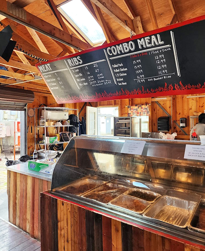 Inside, rustic wooden beams frame a no-nonsense ordering counter where barbecue dreams come true. The menu board tells you everything you need to know about life's priorities.