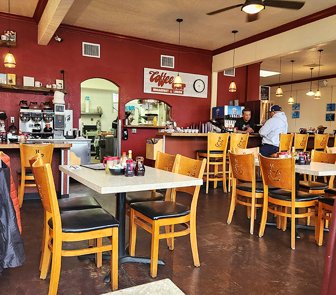 Burgundy walls, wooden chairs with coffee cup designs, and zero pretension. This is where breakfast dreams come true without an Instagram filter in sight.