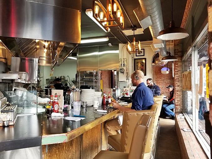 The counter seating offers front-row tickets to the culinary show, where Route 66 memorabilia meets the sizzle and steam of breakfast magic.