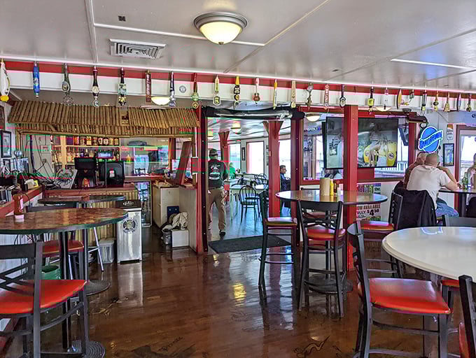 Inside, the nautical charm continues with red accents and fishing memorabilia creating that perfect "I've discovered something special" atmosphere that makes regulars out of first-timers.