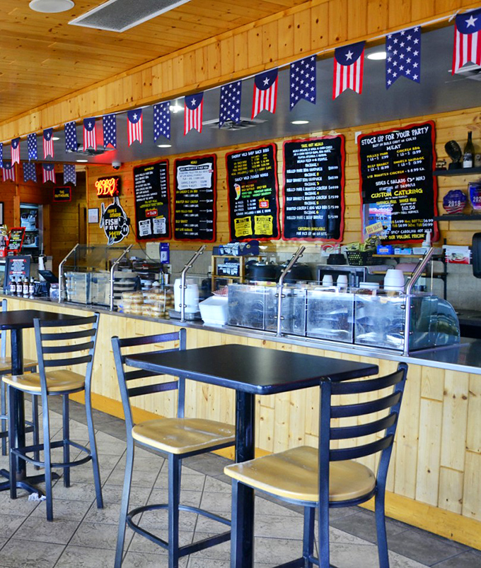 Step inside to a world where patriotic bunting meets pine-paneled warmth, creating the perfect backdrop for BBQ bliss.