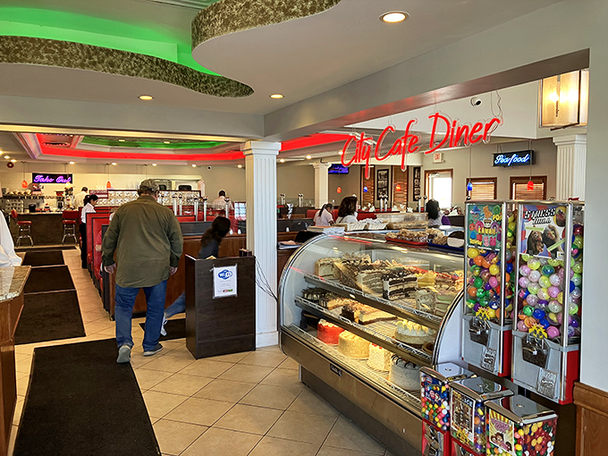 Step inside and feel the buzz of genuine diner energy. The neon glow, dessert case temptations, and bustling atmosphere create that perfect "everybody knows your name" vibe.