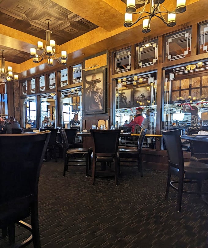 Warm amber lighting, western-themed artwork, and elegant design elements create an atmosphere that says "Yes, you can wear your good boots here."