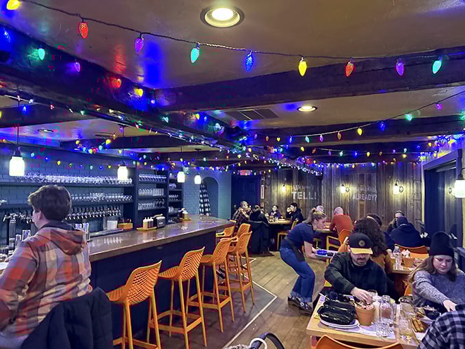 The party never stops under these festive string lights. Bluebird's interior combines rustic wood beams with pops of orange for the perfect barbecue ambiance.