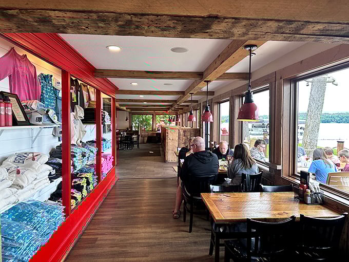 Inside, rustic charm meets lakeside casual with exposed beams, picture windows, and a merchandise corner for souvenir hunters.