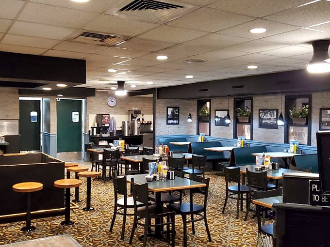 Blue booths and patterned carpet create that classic diner atmosphere where comfort food and conversation flow freely, a time capsule of American dining.