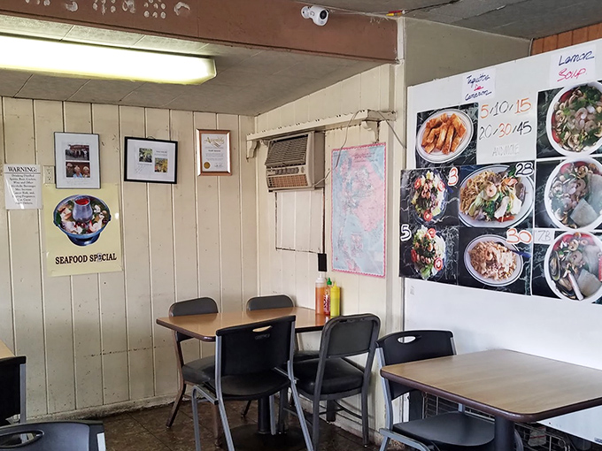 That white door might as well be a portal to flavor country. The modest entrance belies the extraordinary culinary adventure waiting inside.